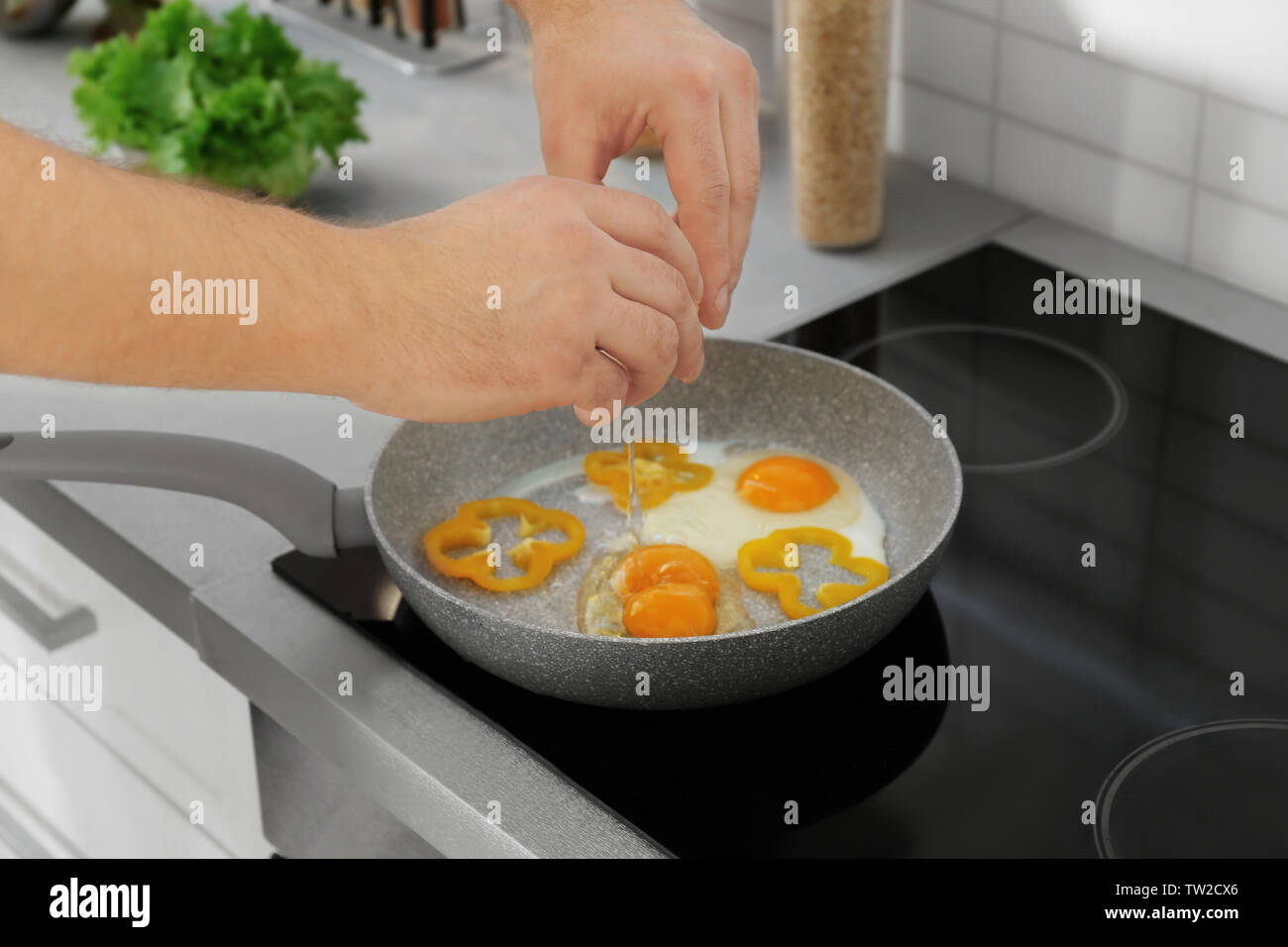 Man frying egg hi-res stock photography and images - Alamy
