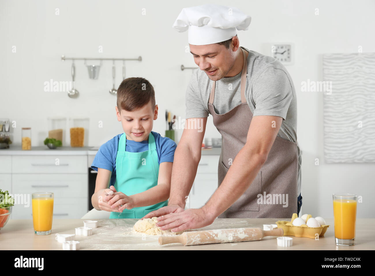 Father and son cooking together in kitchen Stock Photo - Alamy