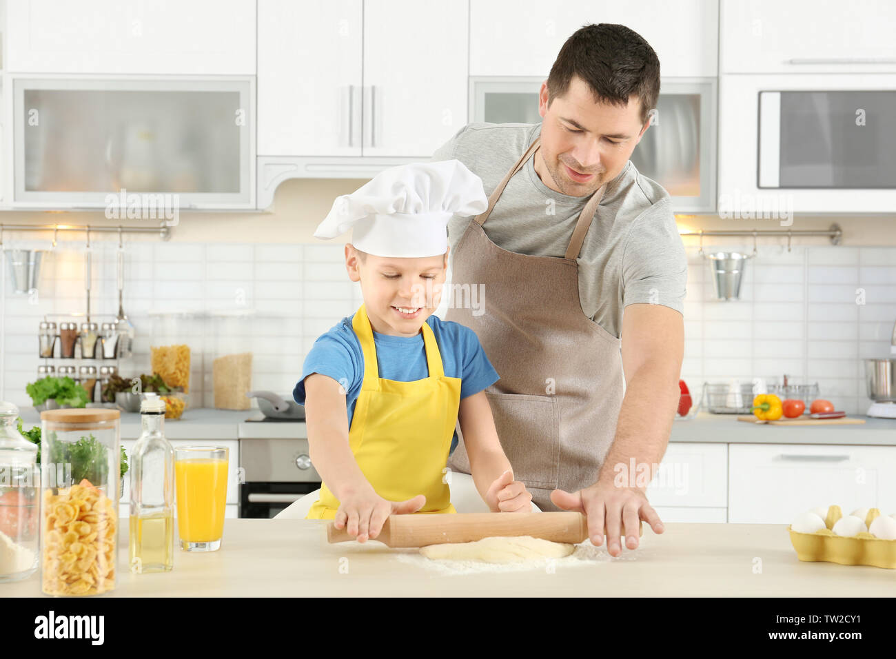 Father and son cooking together in kitchen Stock Photo - Alamy