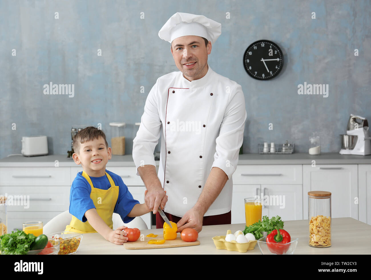 Father and son cooking together in kitchen Stock Photo - Alamy