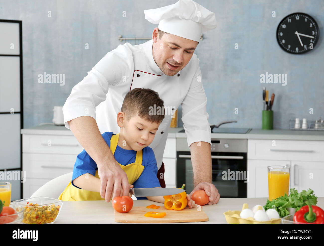 Father and son cooking together in kitchen Stock Photo - Alamy