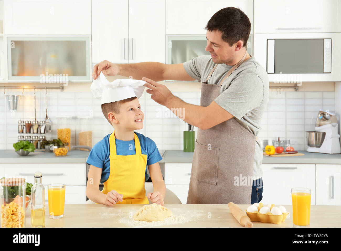 Father and son cooking together in kitchen Stock Photo - Alamy
