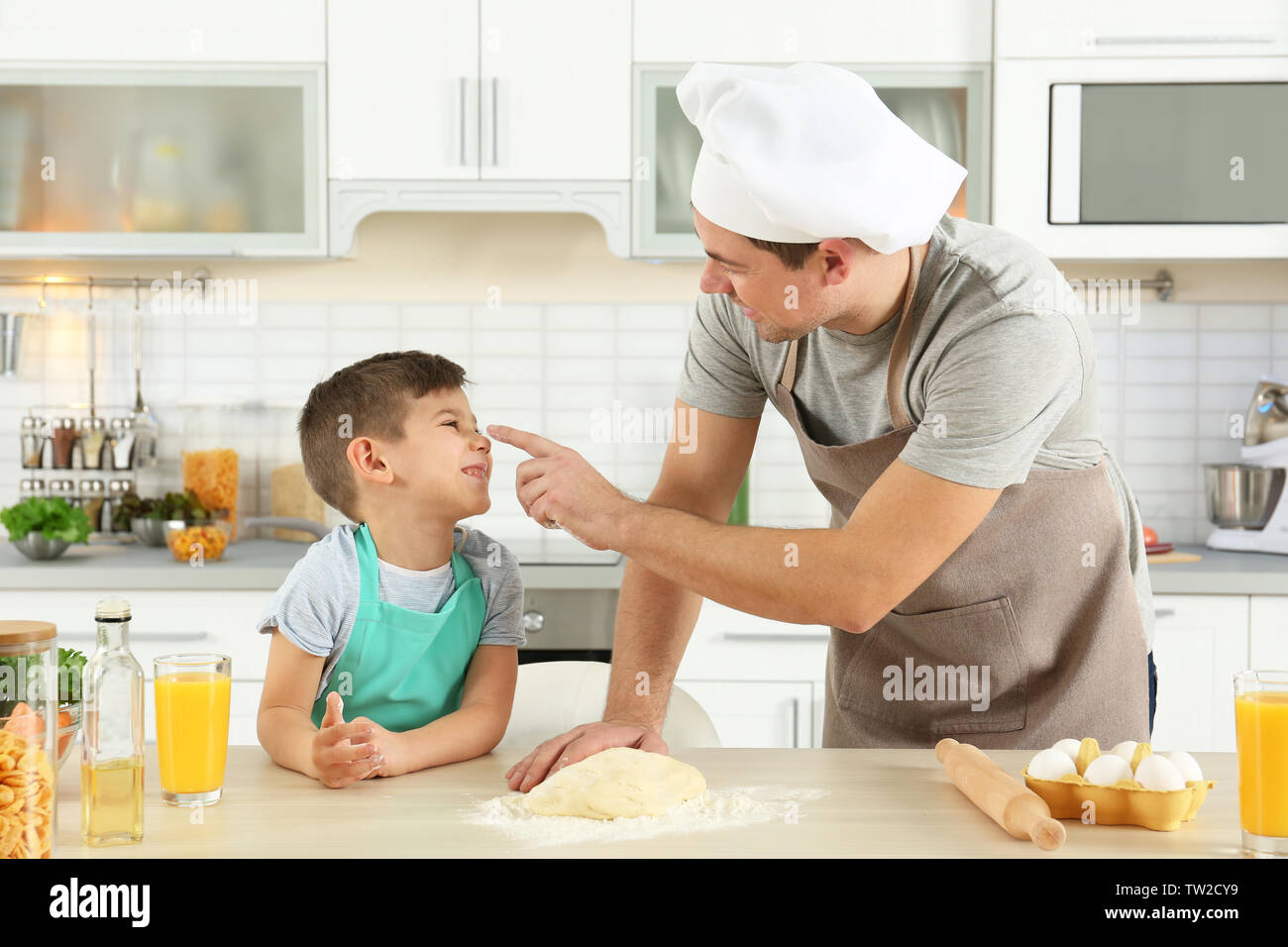 Father and son cooking together in kitchen Stock Photo - Alamy