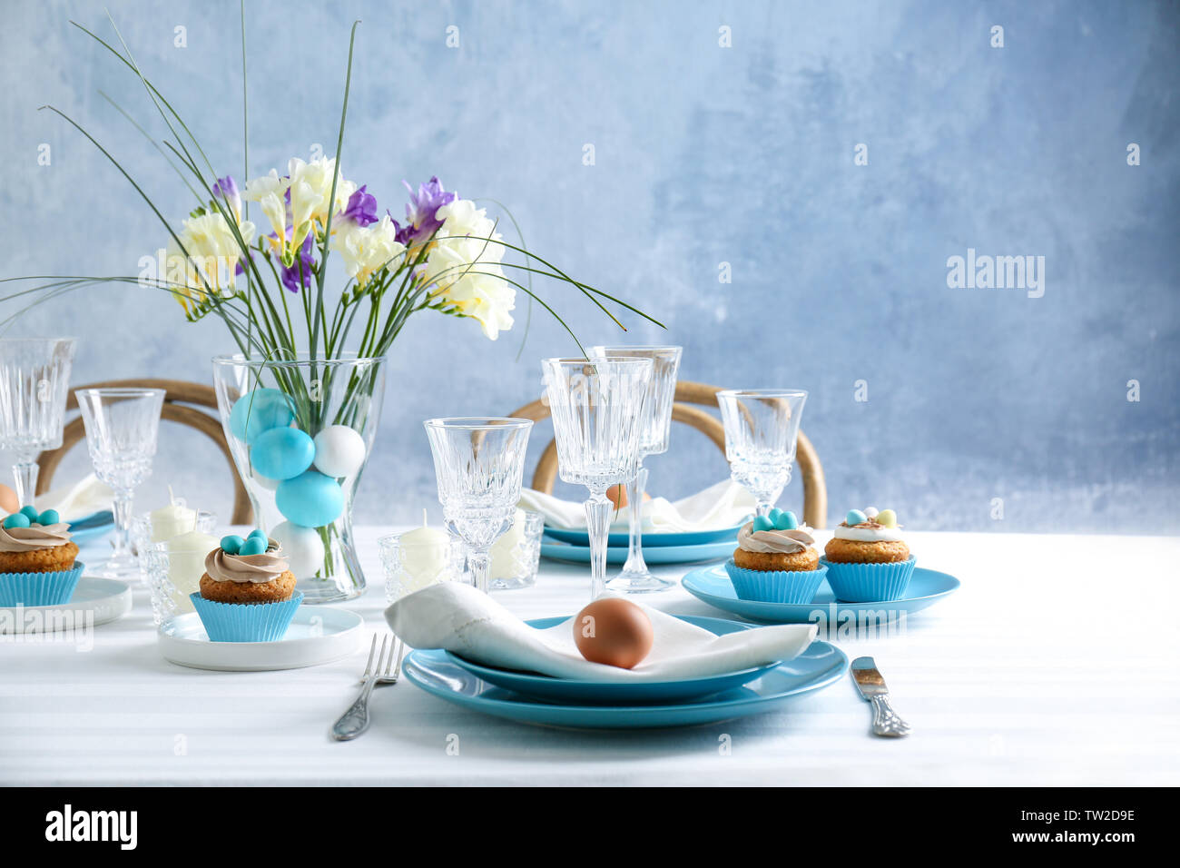 Beautiful Easter table setting with blue plate Stock Photo - Alamy
