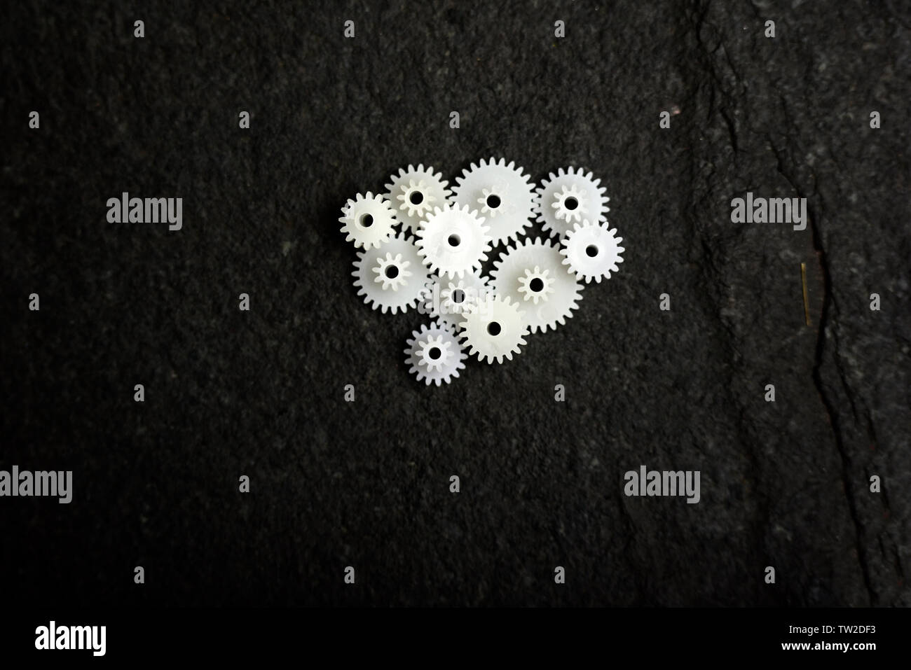White wheel gears are on black texture background Stock Photo - Alamy