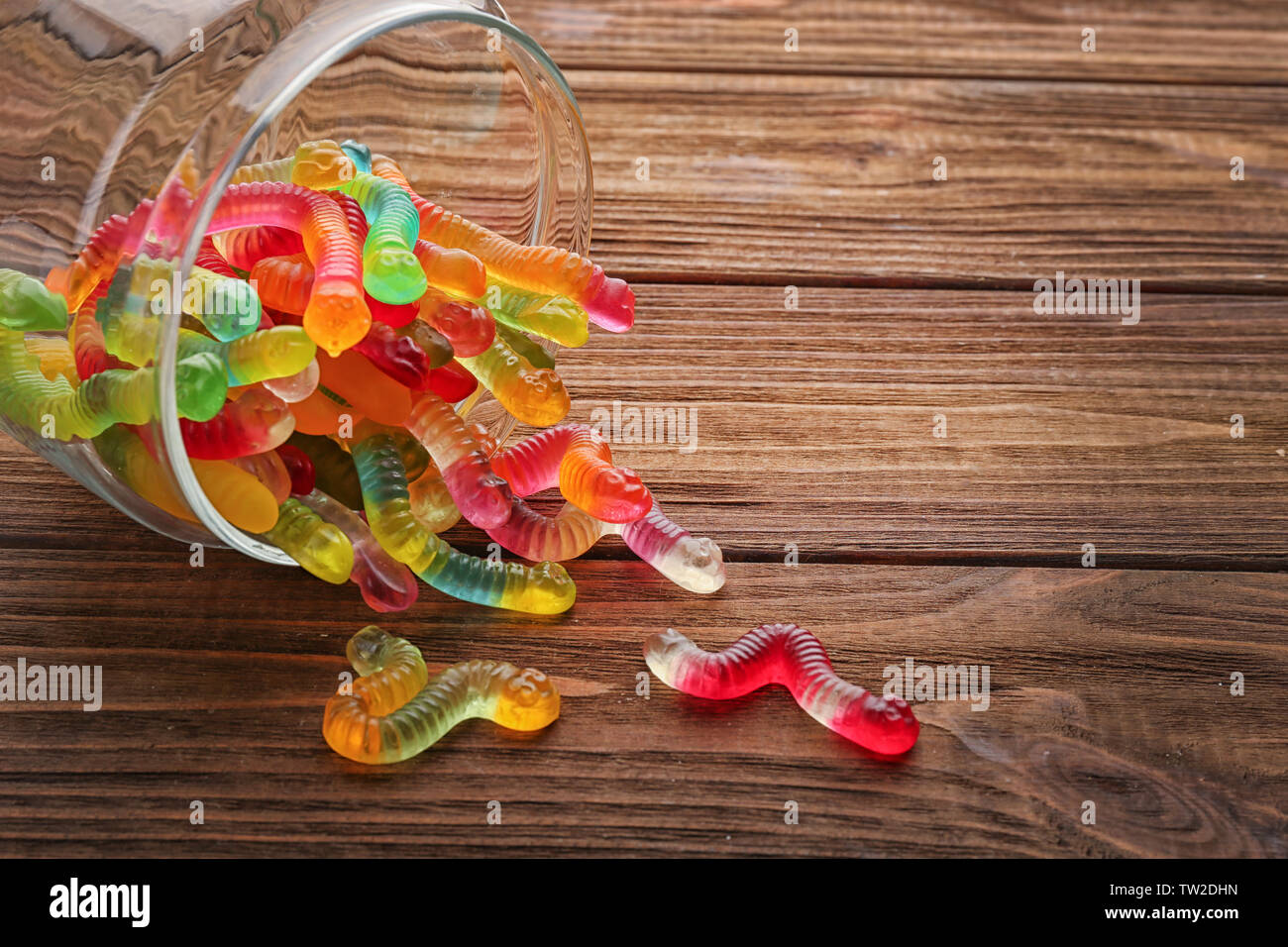 Glass jar with tasty jelly worms on wooden background Stock Photo - Alamy