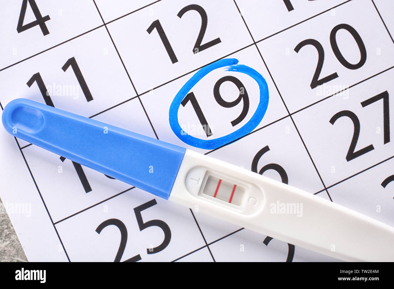 Pregnancy test and marked date on calendar Stock Photo - Alamy