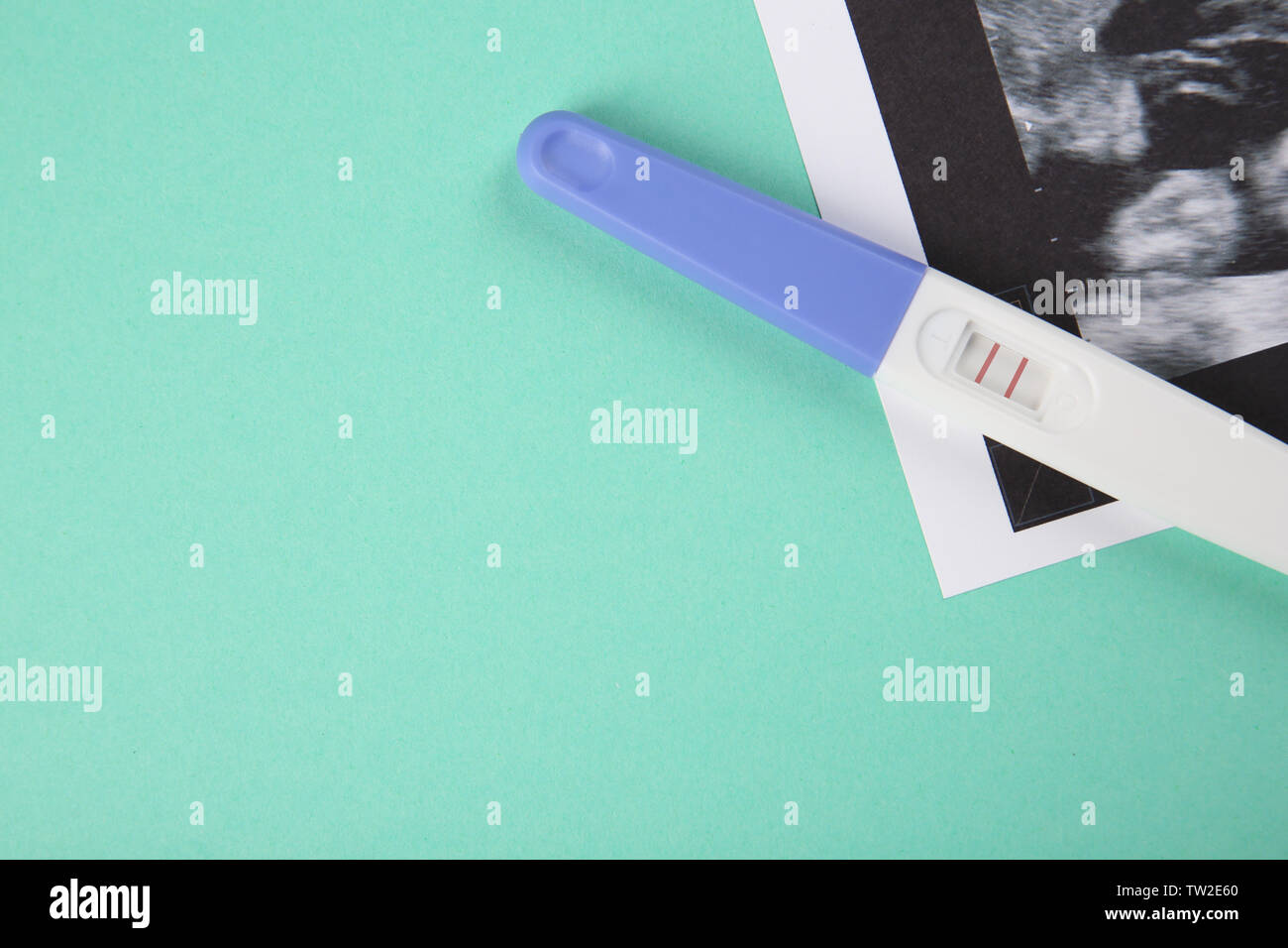 Ultrasound photo and pregnancy test on turquoise background Stock Photo ...