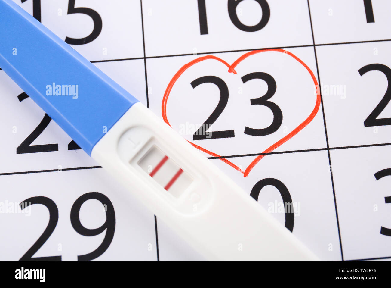 Pregnancy test and marked date on calendar Stock Photo - Alamy