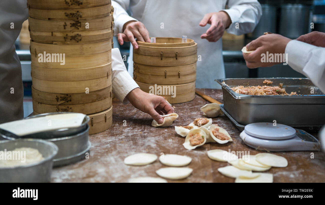 Taiwanese team of chefs cooking traditional food. Asian chef making ...