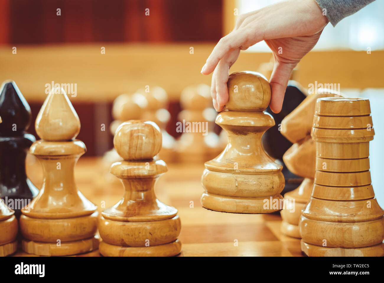 hand holding a large chess piece over the Board Stock Photo - Alamy