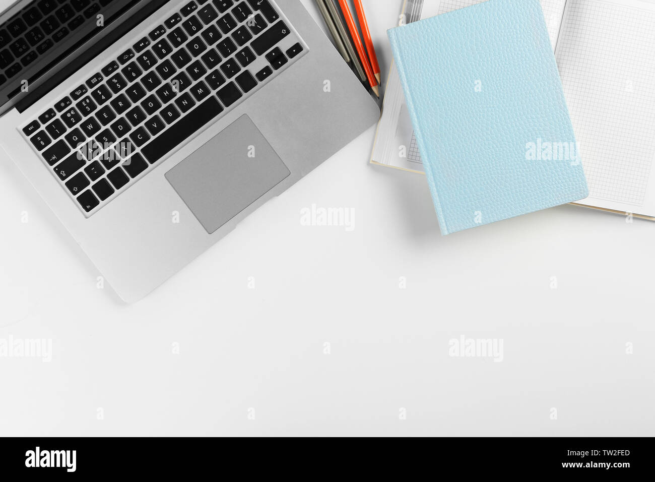 Laptop, notebooks and pencils on white background Stock Photo - Alamy