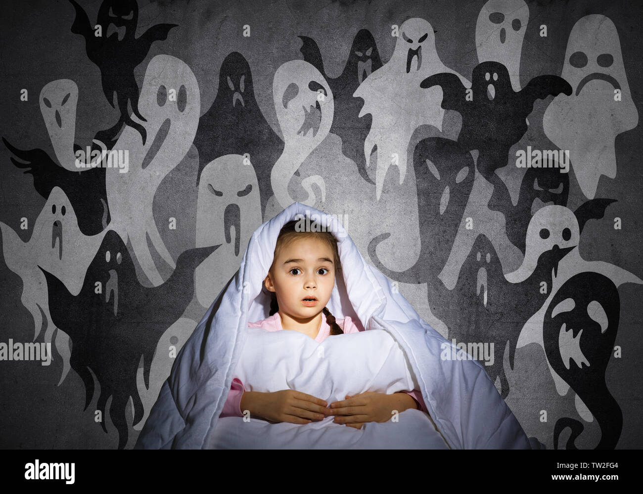 Excited girl hiding under blanket from imaginary ghosts. Scared kid ...