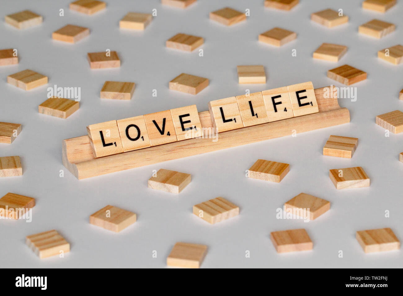 Scrabble Word Game wood tiles spelling "Love Life Stock Photo - Alamy