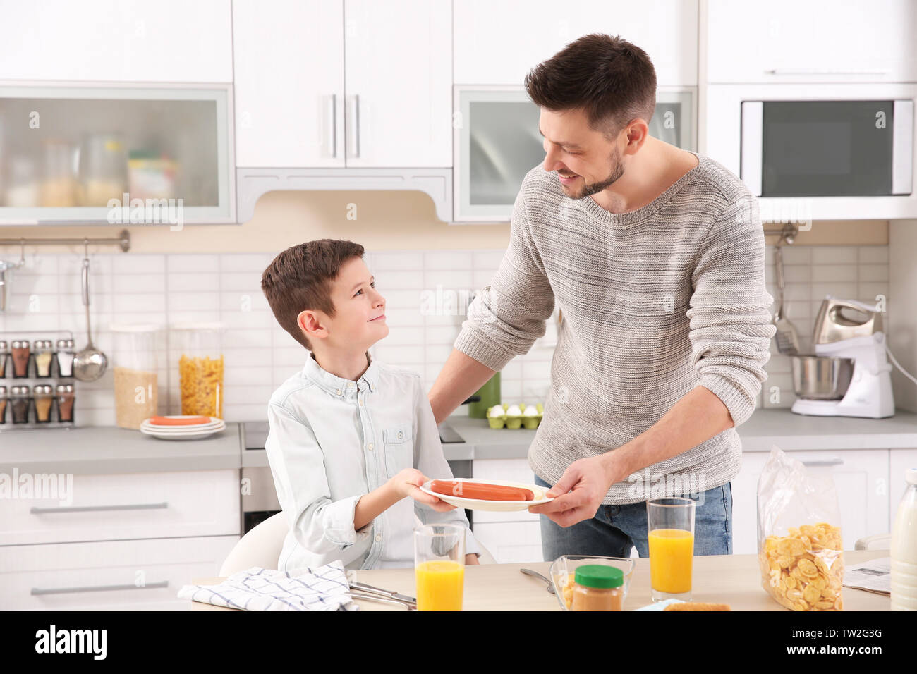 Dad and son preparing to have lunch at home Stock Photo - Alamy