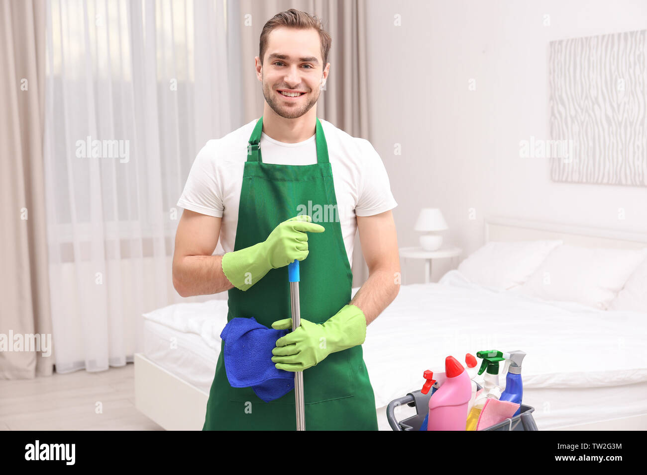 Male house cleaner in uniform hi-res stock photography and images - Alamy