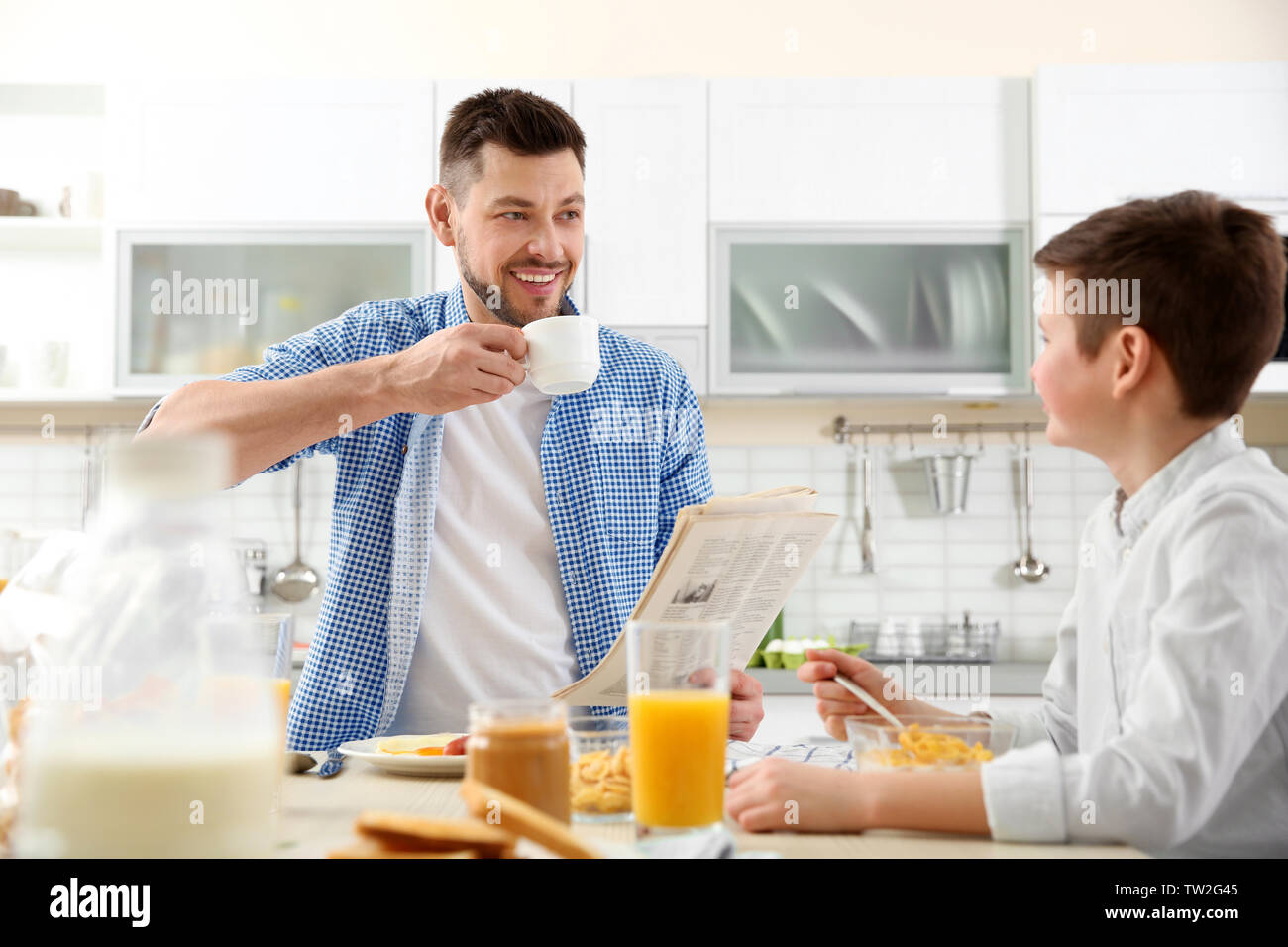 Dad and son having lunch at home Stock Photo - Alamy