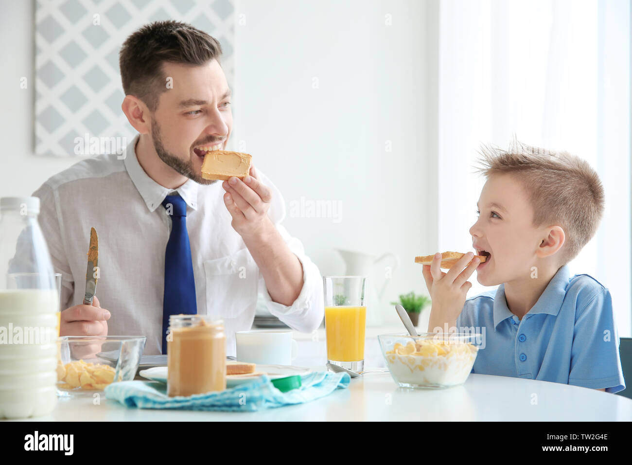 Dad and son having lunch at home Stock Photo - Alamy