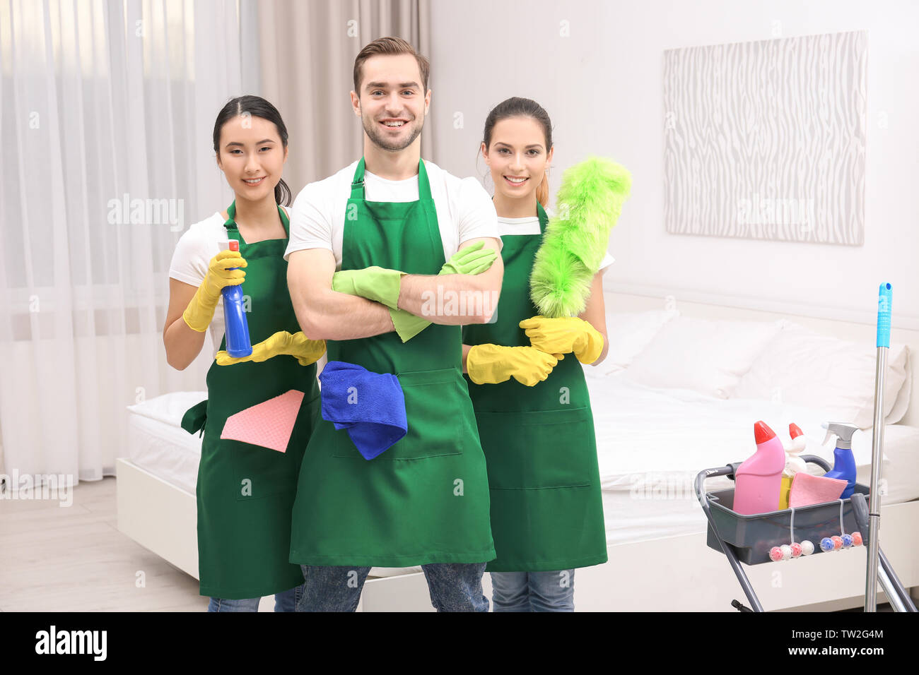 Cleaning service team at work in bedroom Stock Photo - Alamy