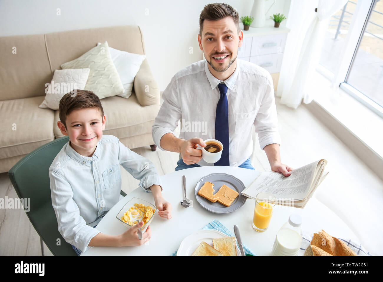 Dad and son having lunch at home Stock Photo - Alamy