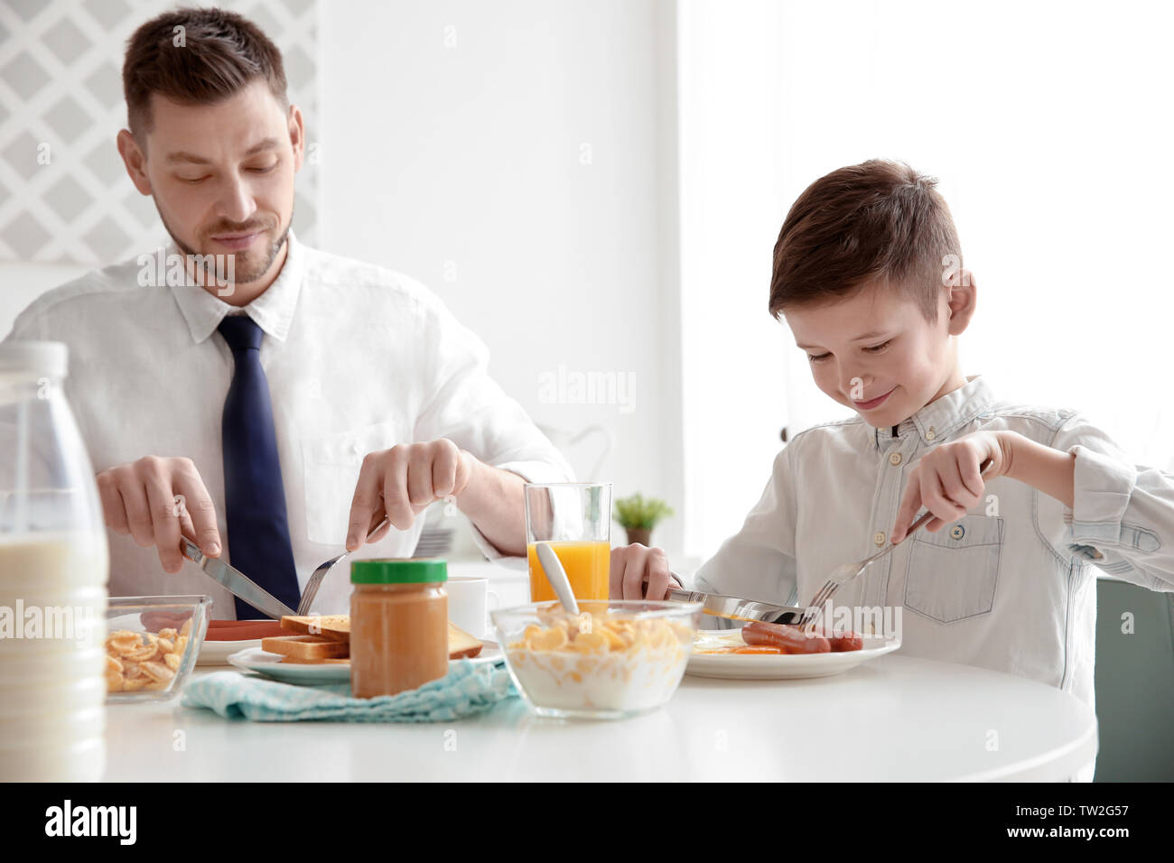 Dad and son having lunch at home Stock Photo - Alamy