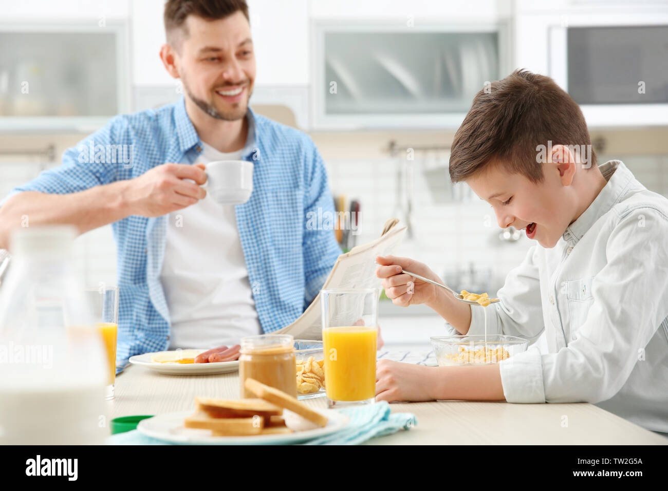Dad and son having lunch at home Stock Photo - Alamy