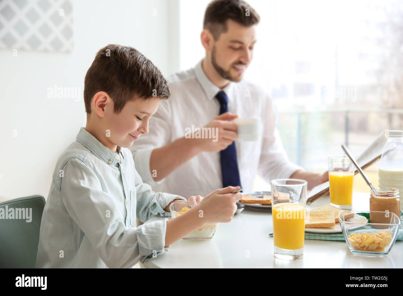 Dad and son having lunch at home Stock Photo - Alamy