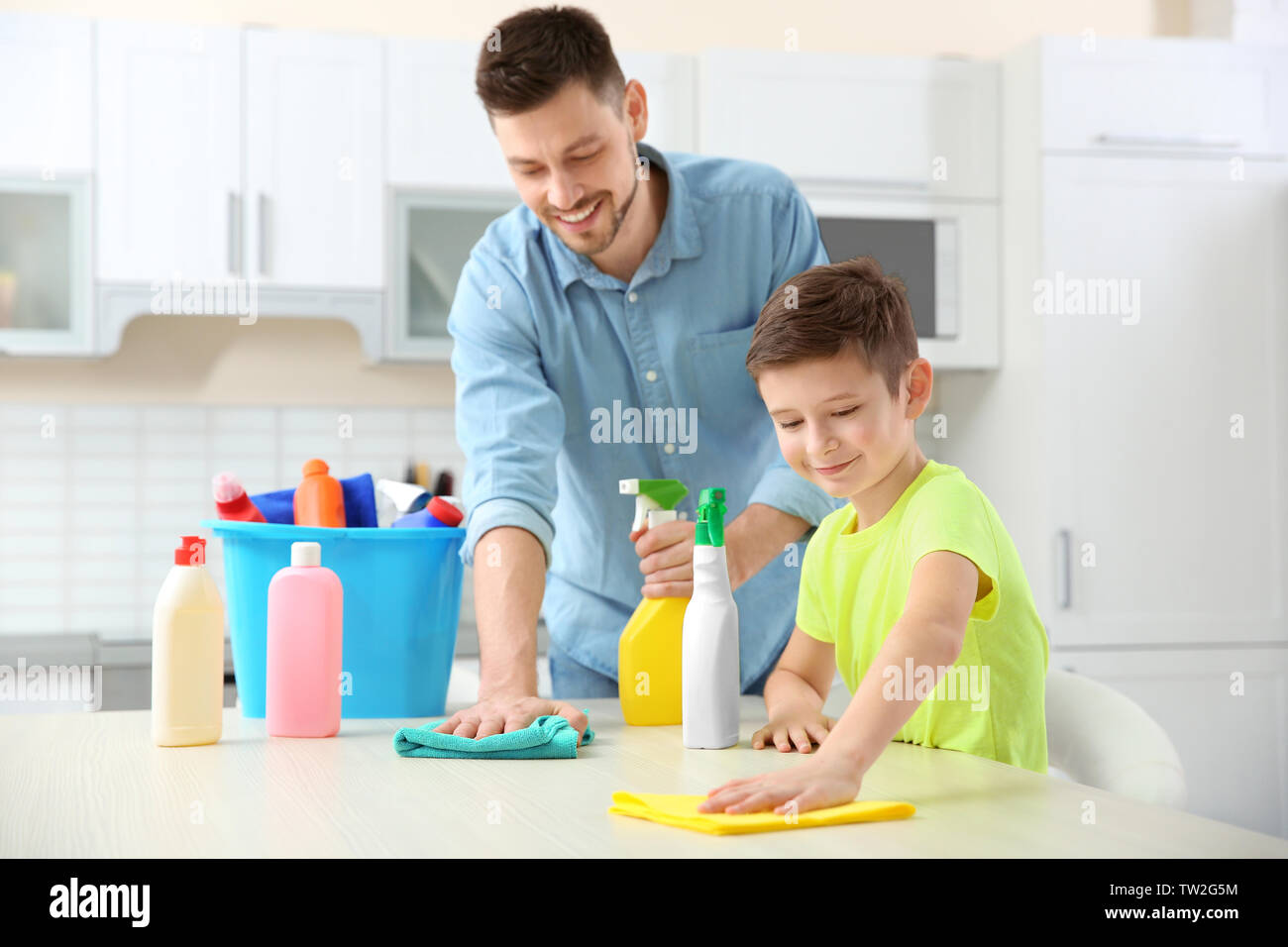 Dad and son doing cleaning at home Stock Photo - Alamy