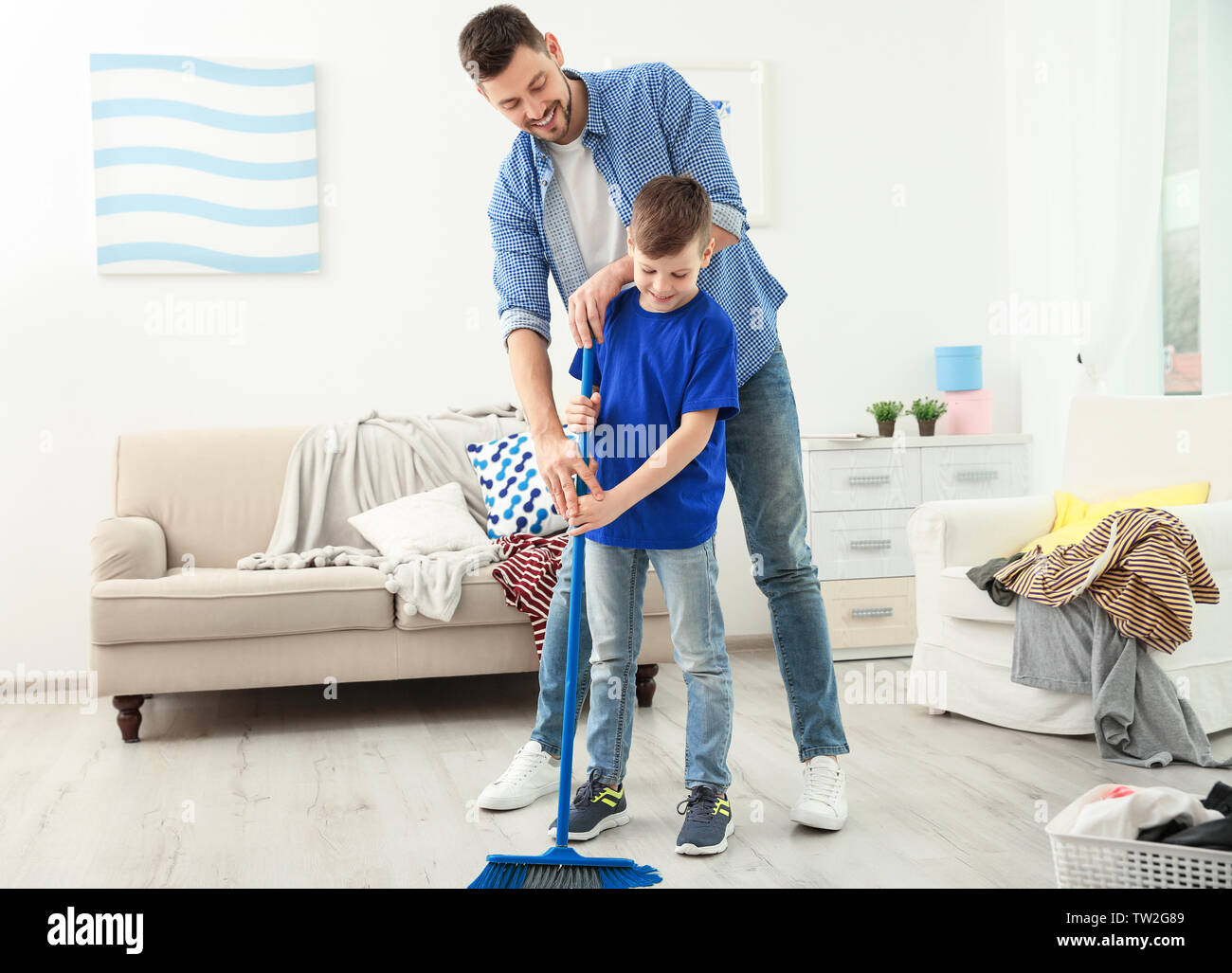 Father son sweeping floor hi-res stock photography and images - Alamy