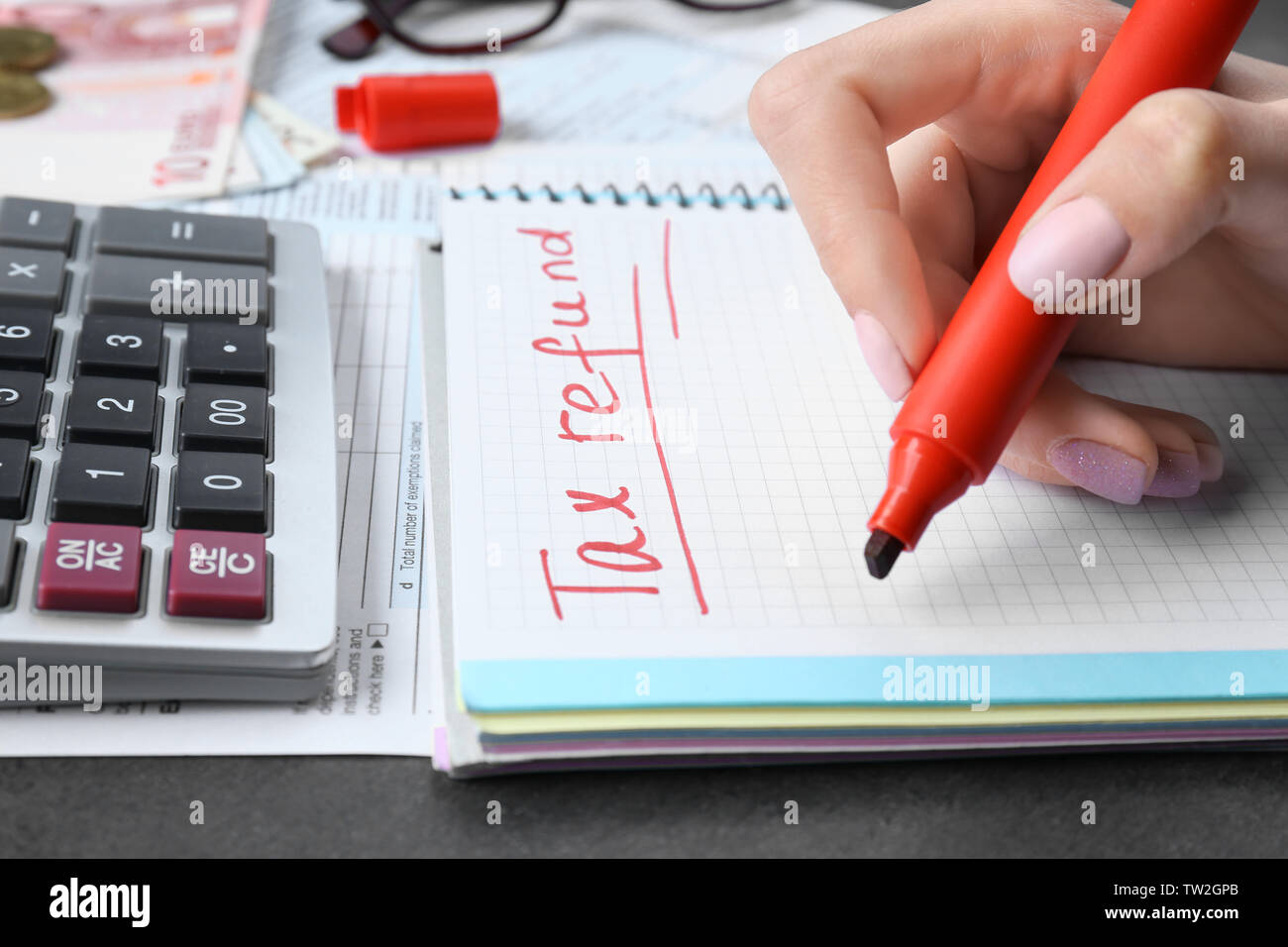 Woman making notes in notebook, closeup. Tax refund concept Stock Photo ...