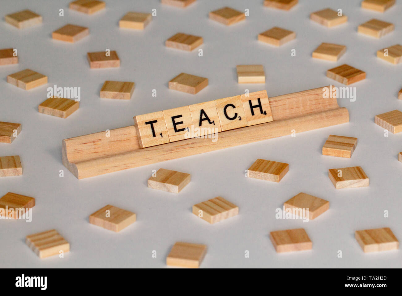Scrabble Word Game wood tiles spelling "Teach Stock Photo - Alamy