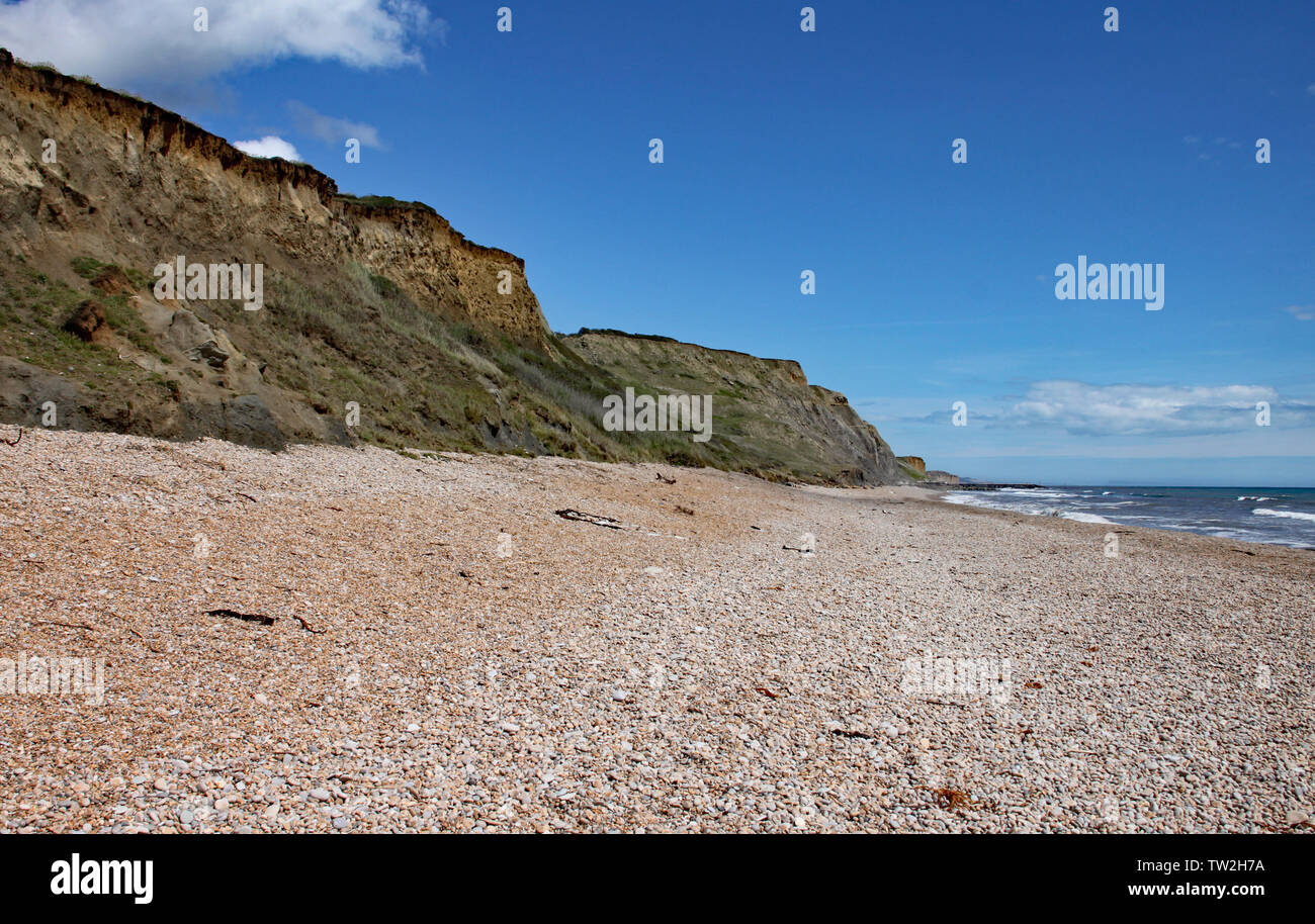 The shingle beach at Eype in Dorset on a sunny day, The sandstone ...