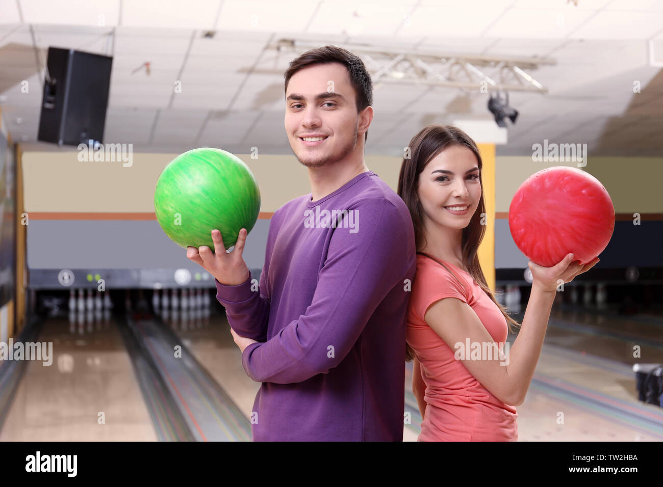 Young man and woman having fun at bowling club Stock Photo - Alamy