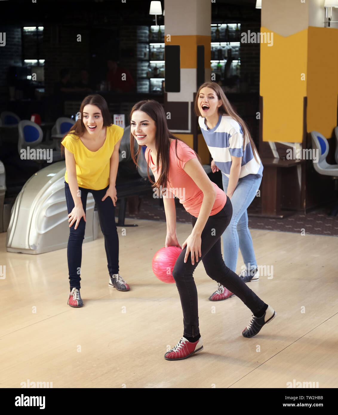 Friends having fun at bowling club Stock Photo - Alamy