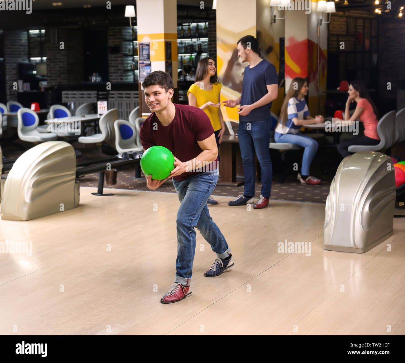 Friends having fun at bowling club Stock Photo - Alamy