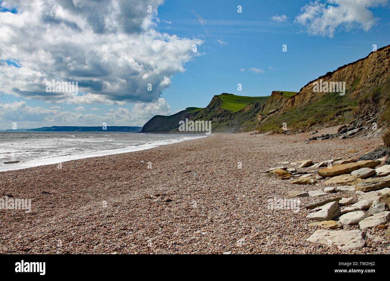 The shingle beach at Eype in Dorset on a sunny day, The sandstone ...
