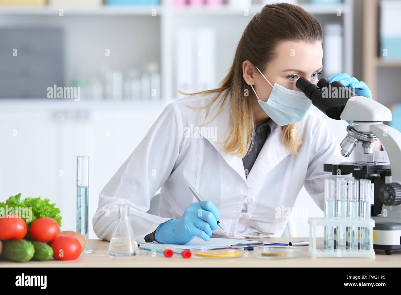 Young female nutritionist testing food samples in laboratory Stock ...
