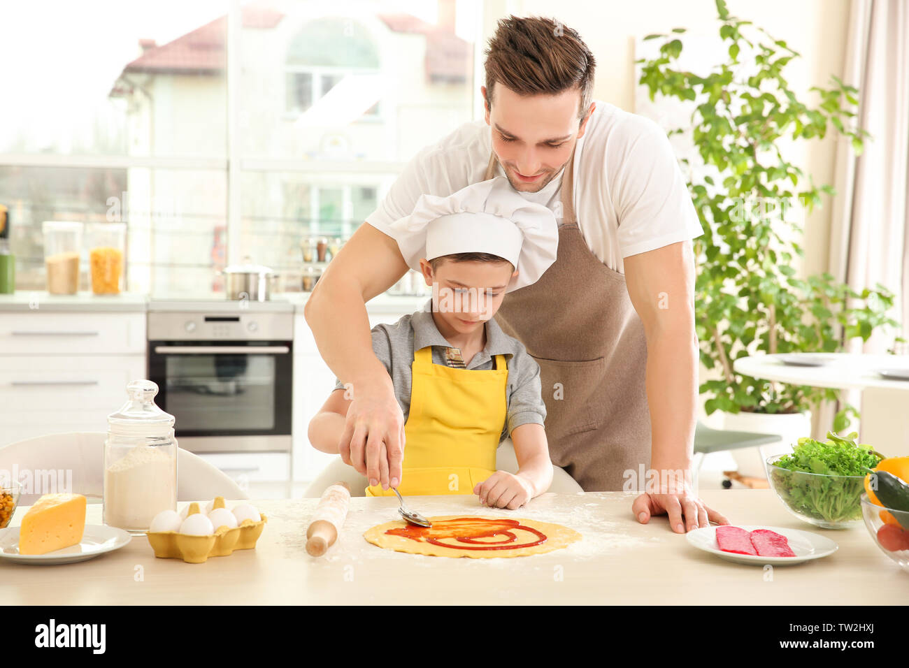 Dad and son cooking at home Stock Photo - Alamy