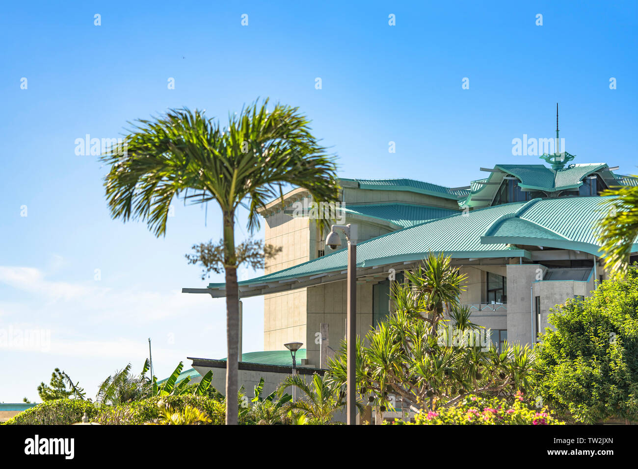 Building of Okinawa Convention Center decorated with palm trees near ...