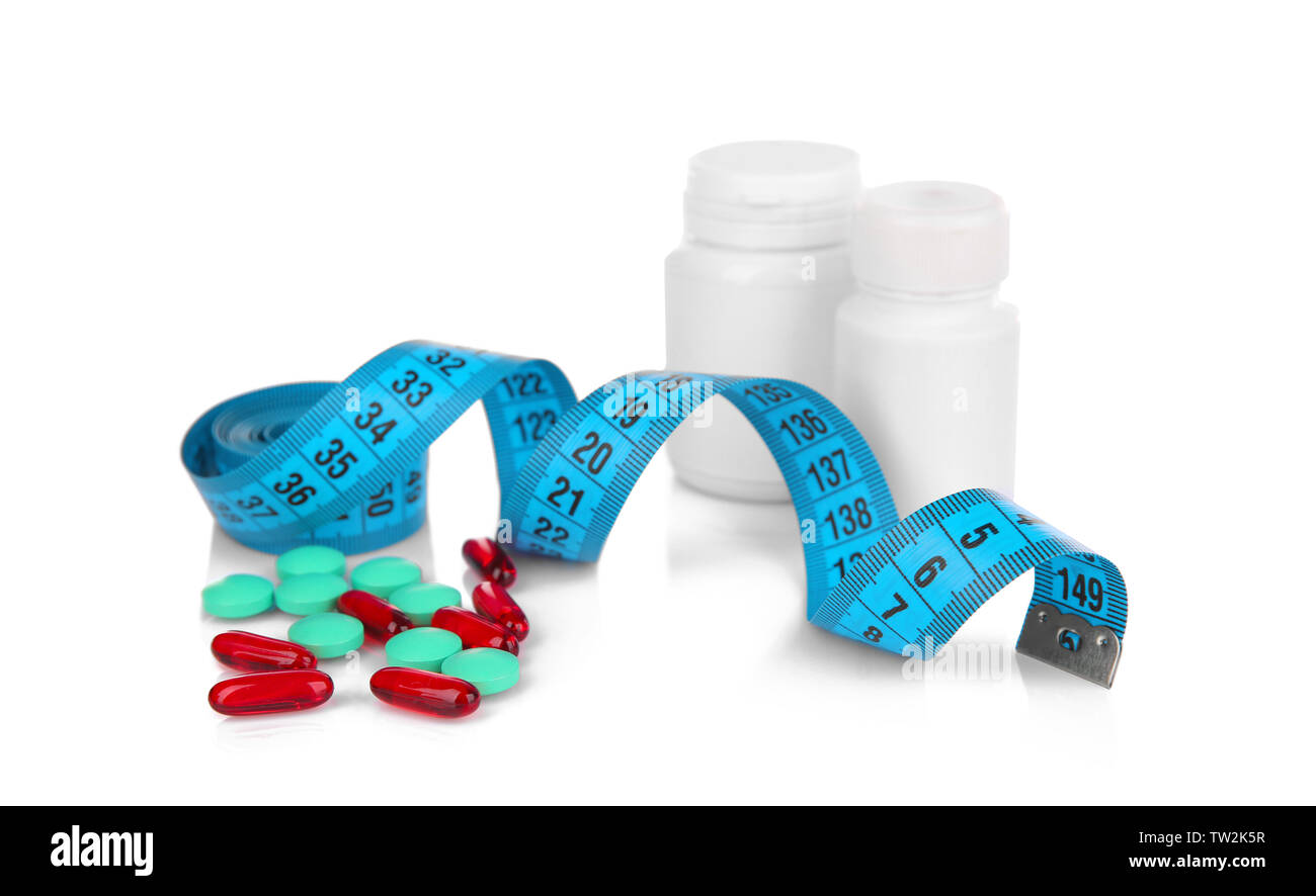 Weight loss concept. Measuring tape and pills on white background Stock ...