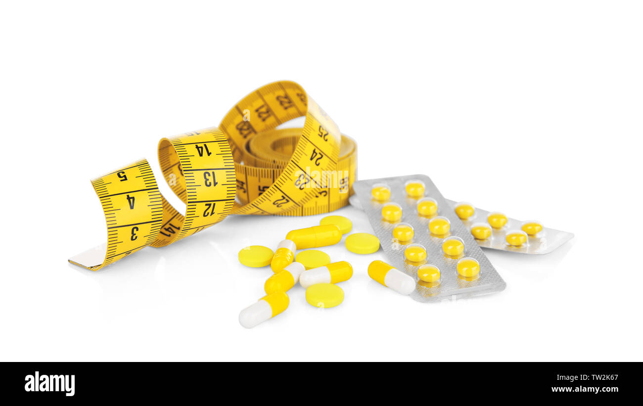 Weight loss concept. Measuring tape and pills on white background Stock ...