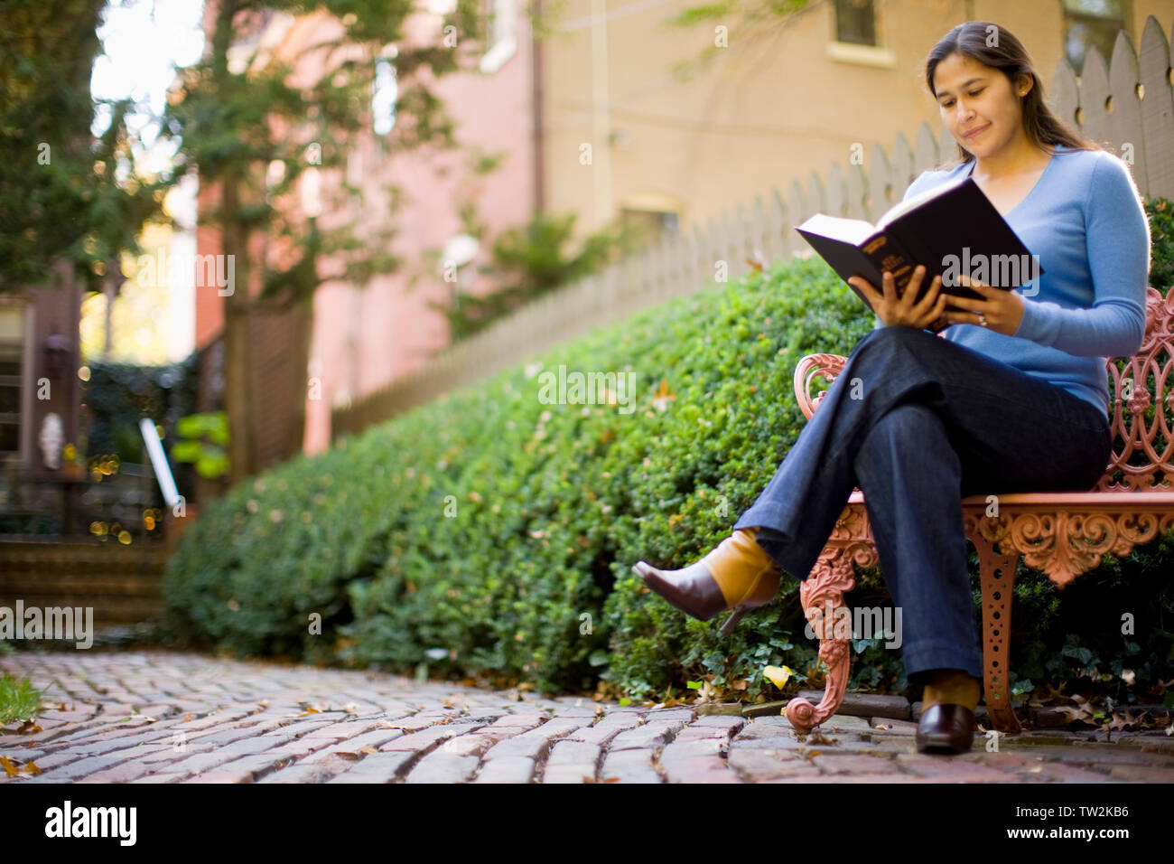 Girl reading a book outside Stock Photo - Alamy