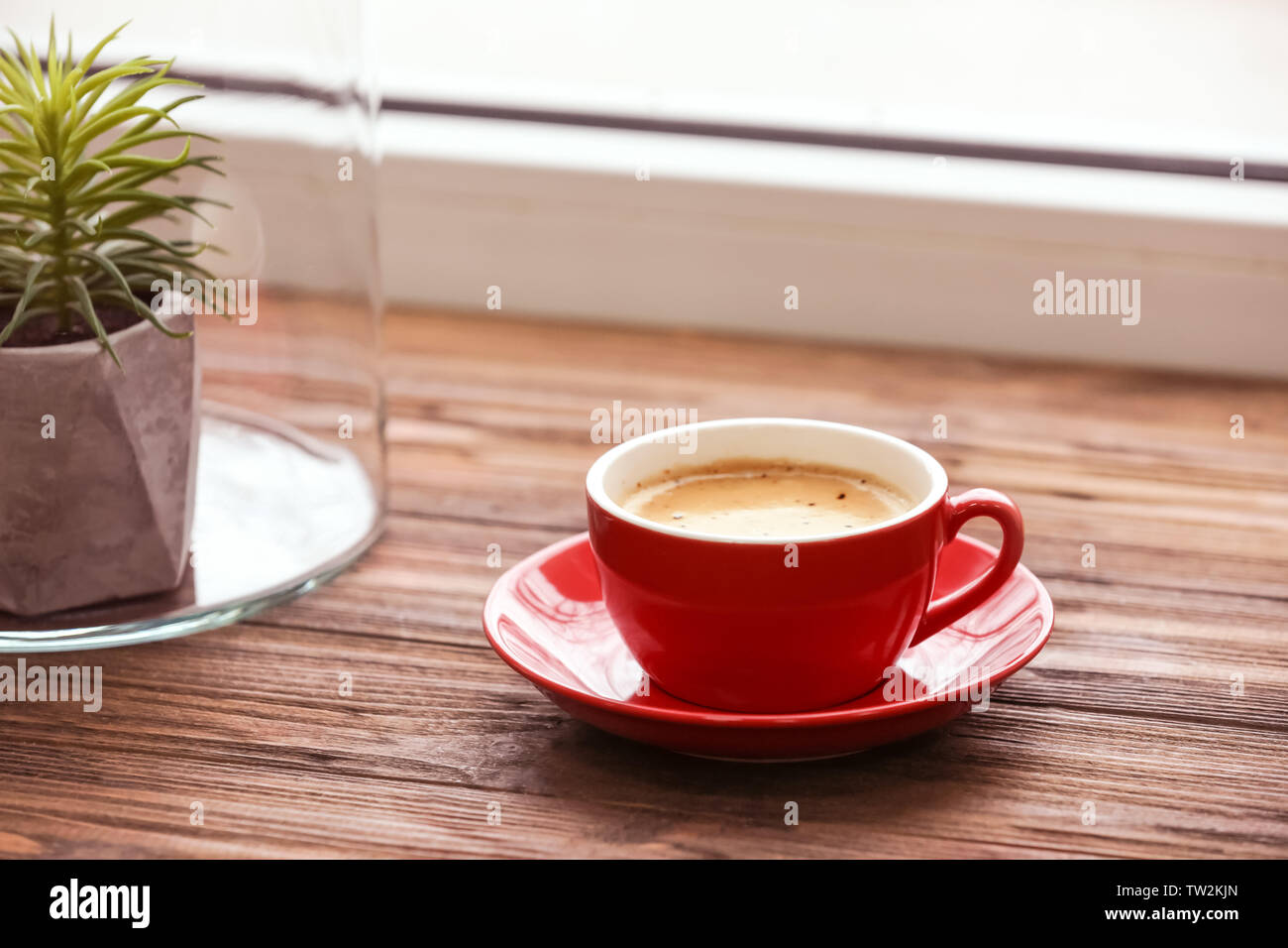 Cup of hot coffee on window sill Stock Photo - Alamy