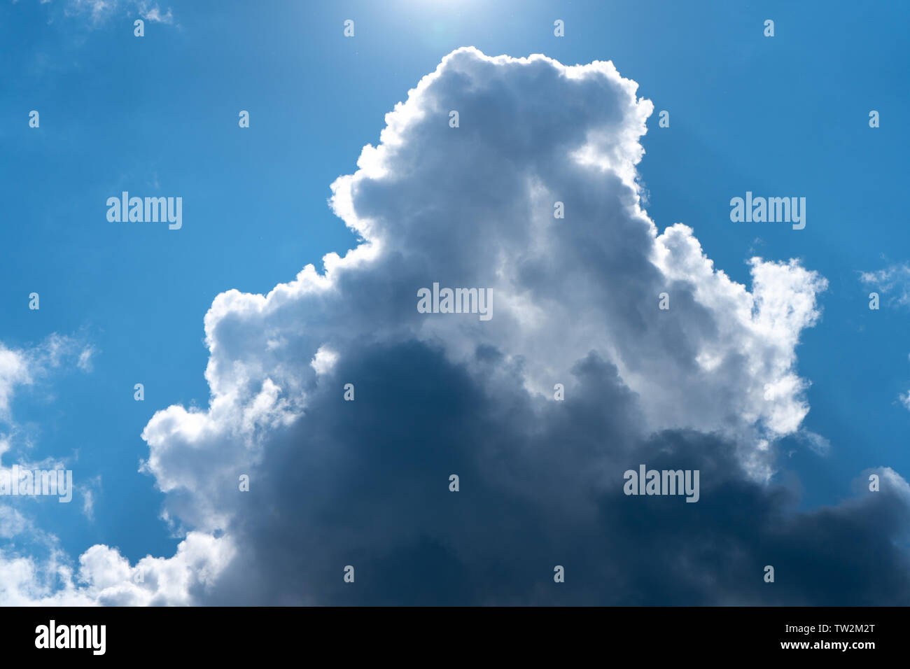 Luminous clouds set against a dark blue sky in the sun. Wonderful blue ...