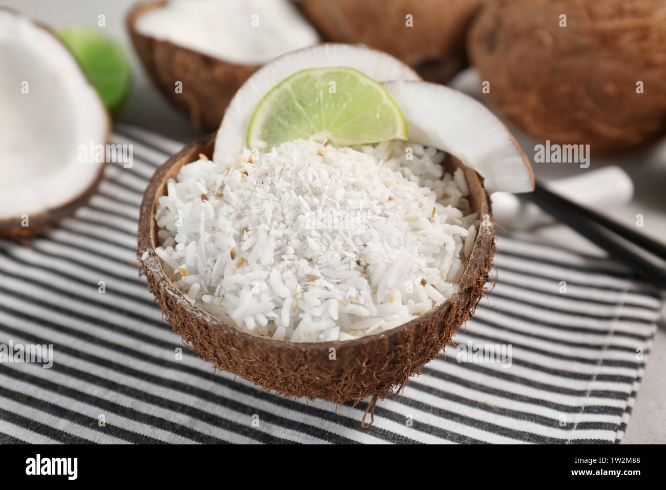Tasty rice in coconut shell on table Stock Photo - Alamy