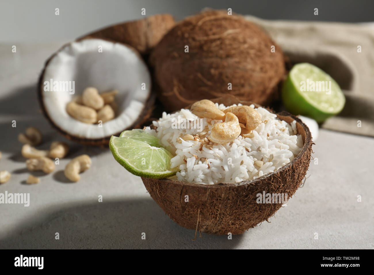Tasty rice in coconut shell on table Stock Photo - Alamy