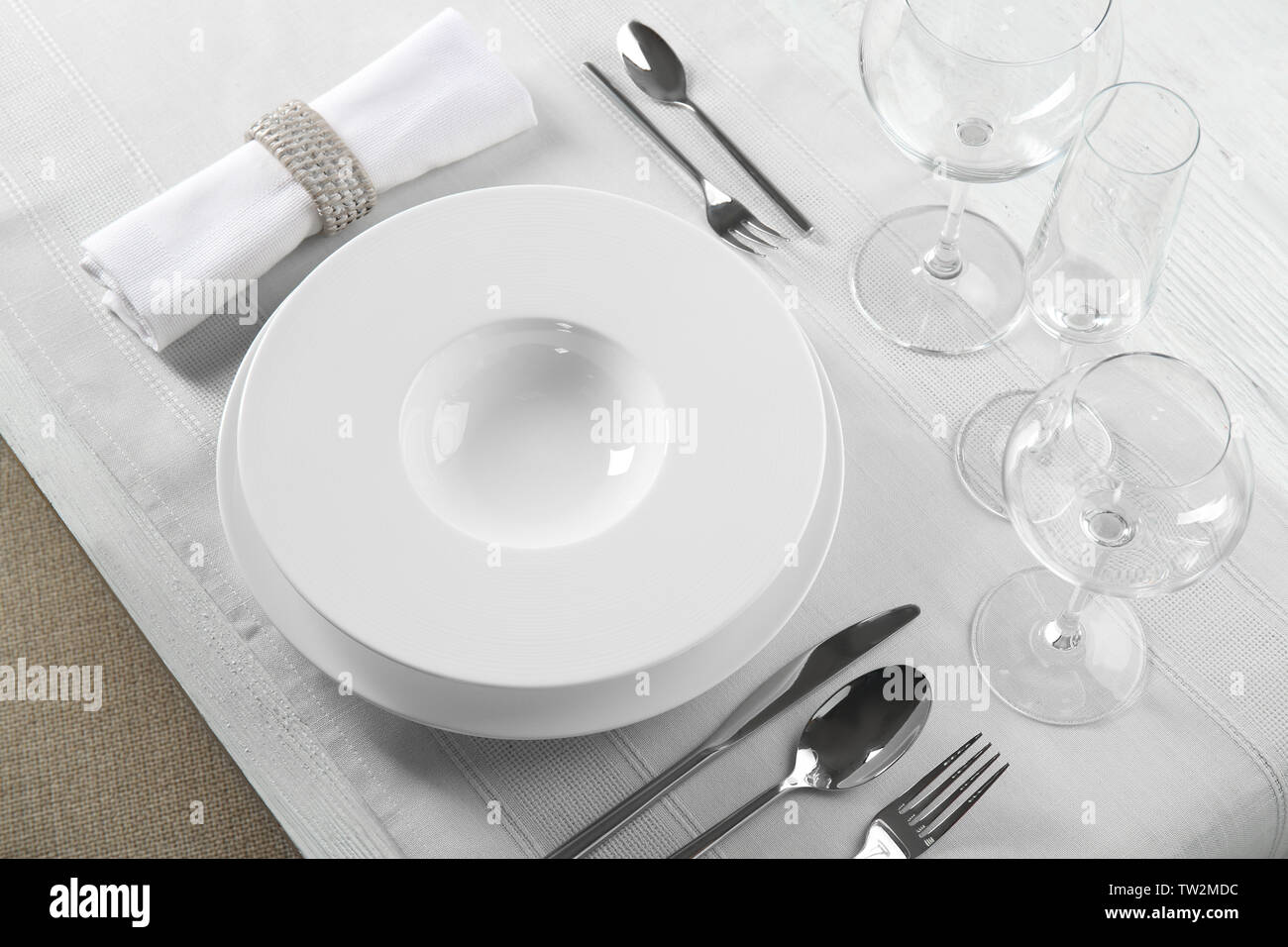 Table setting with plates and cutlery, closeup Stock Photo - Alamy