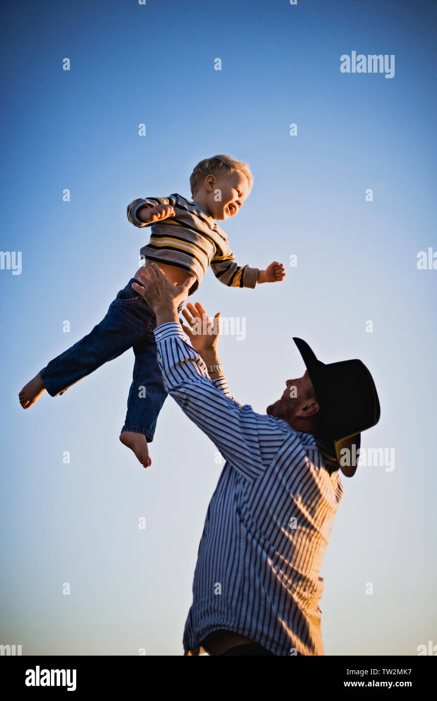 Dad throwing baby in air hi-res stock photography and images - Alamy