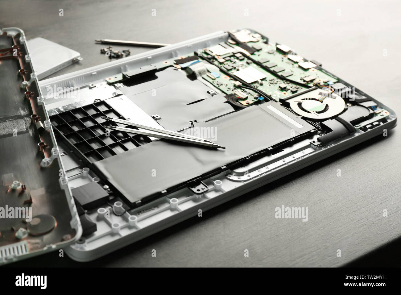 Dismantled laptop with tools on table. Concept of computer repair Stock ...