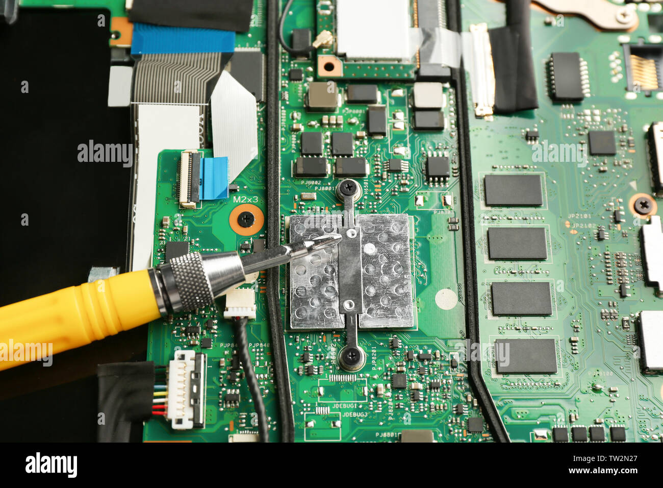 Motherboard in dismantled laptop and screwdriver, closeup. Concept of ...